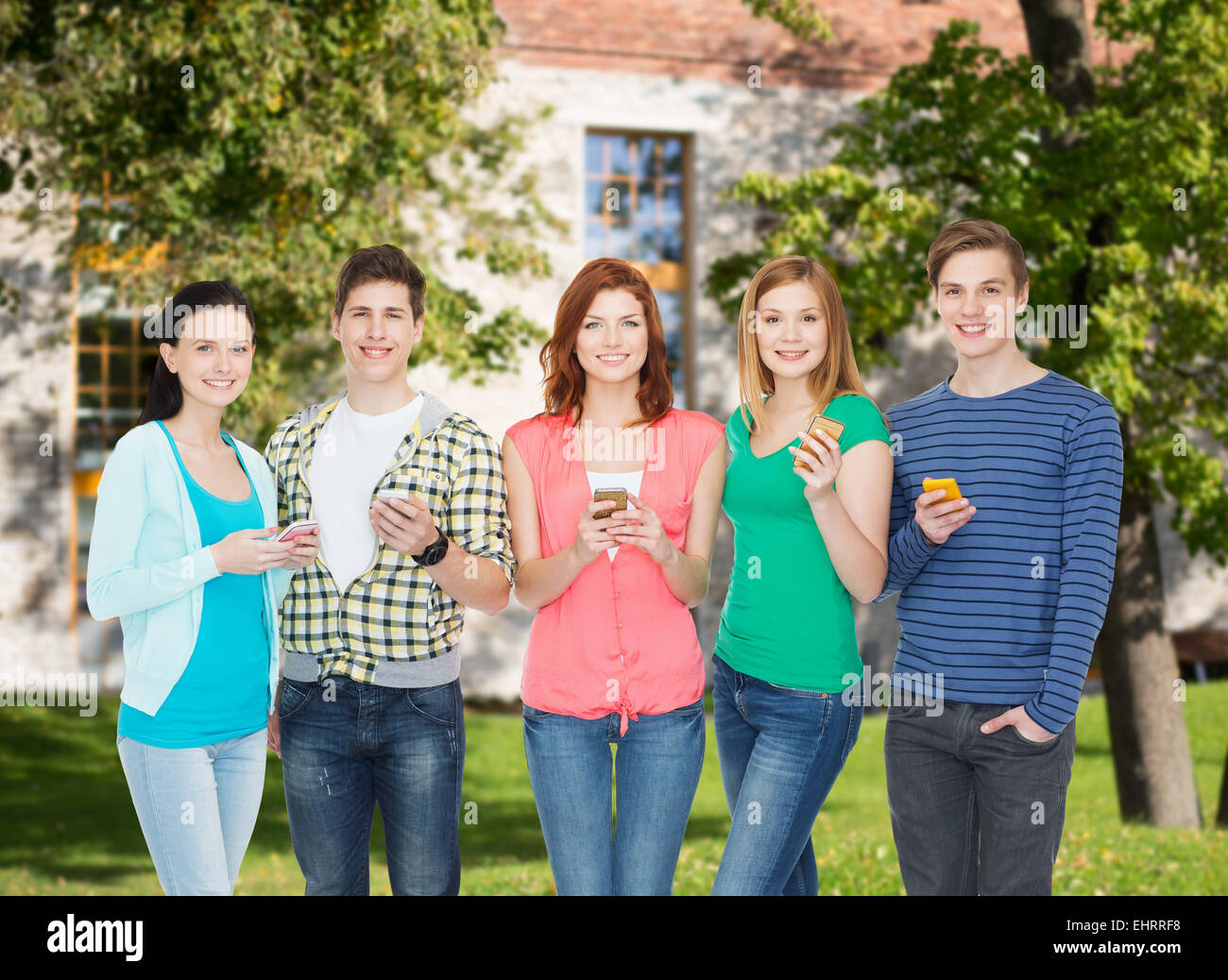smiling students with smartphones Stock Photo - Alamy