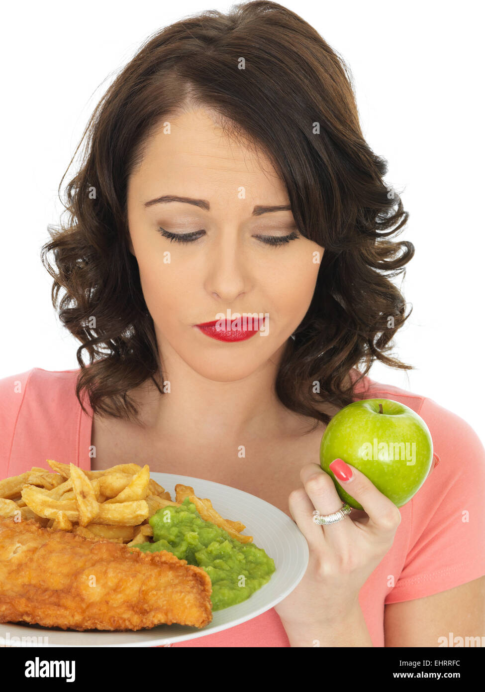 Young Woman Eating Chip Shop Takeaway Fish And Chips Isolated Against A ...