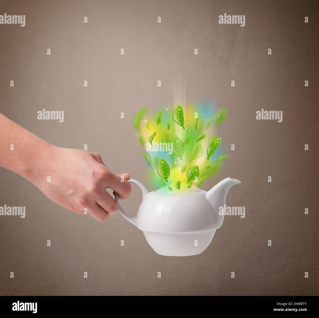 Tea pot with leaves and colorful abstract lights Stock Photo - Alamy