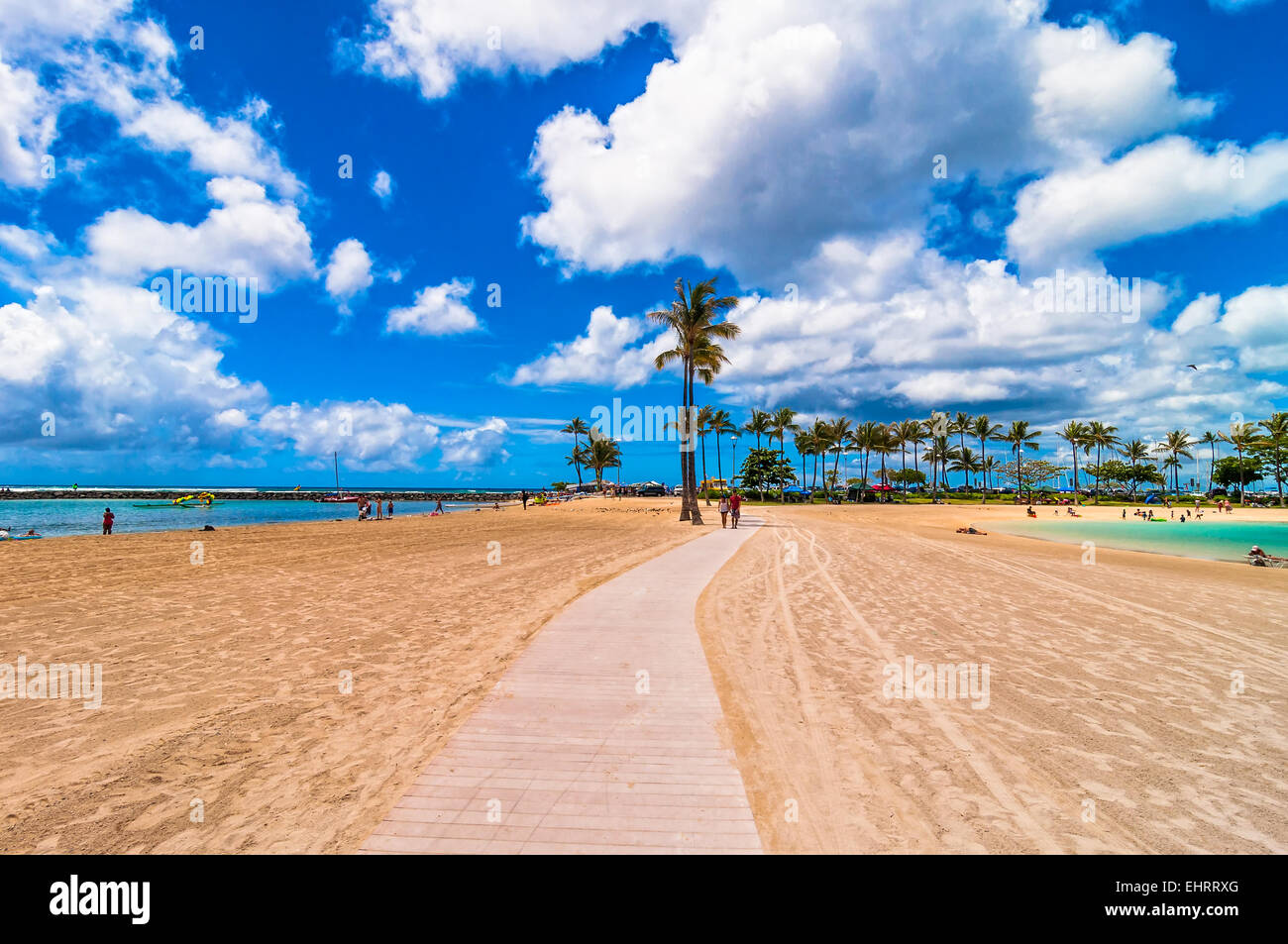 tourists sunbathing and swimming on Waikiki beach in Honolulu, Hawaii ...