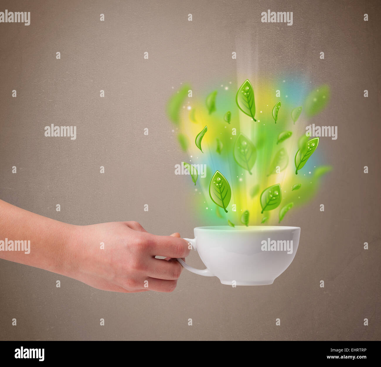 Tea cup with leaves and colorful abstract lights Stock Photo - Alamy