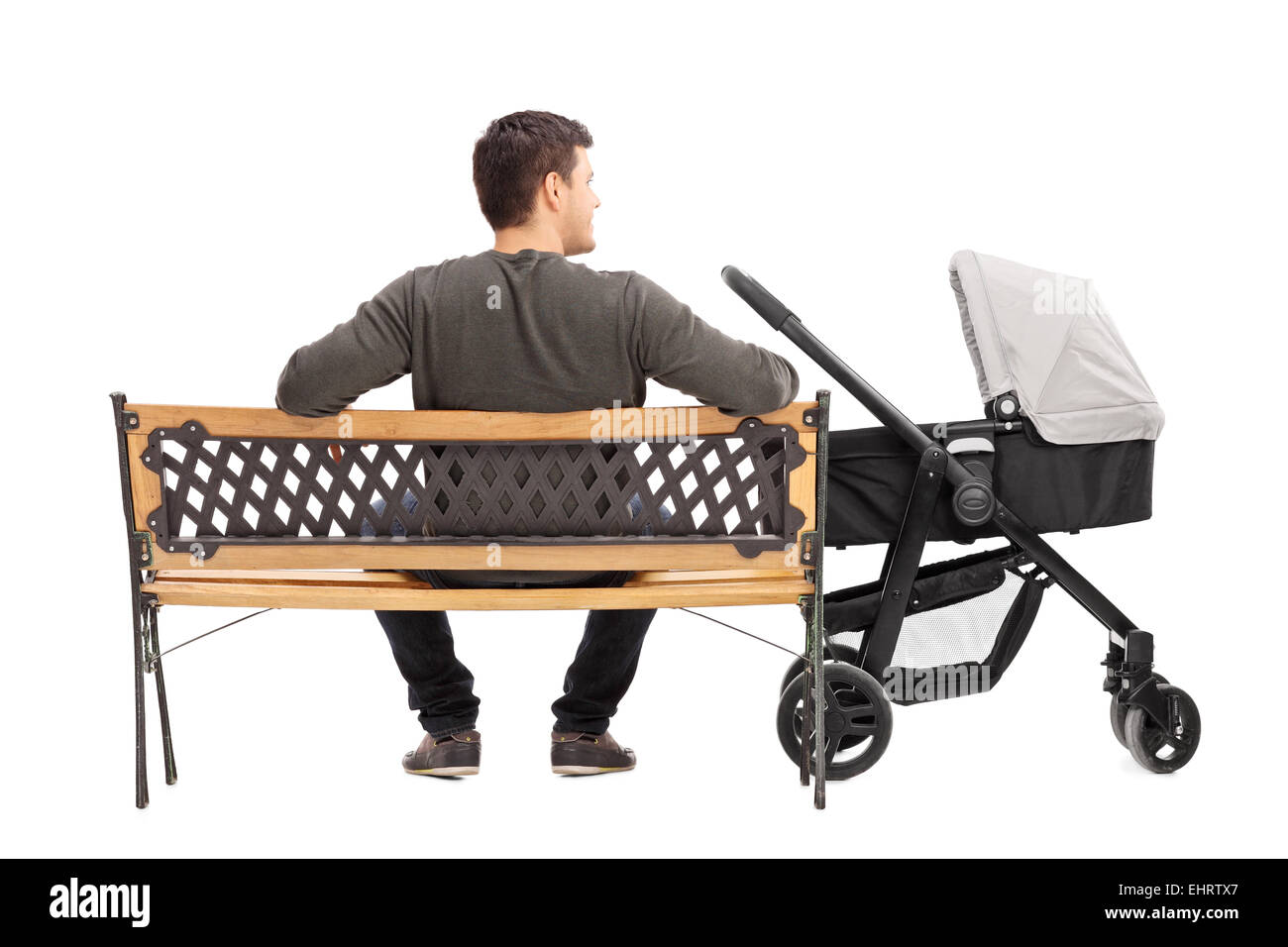 Rear view studio shot of a young father sitting on bench with baby ...