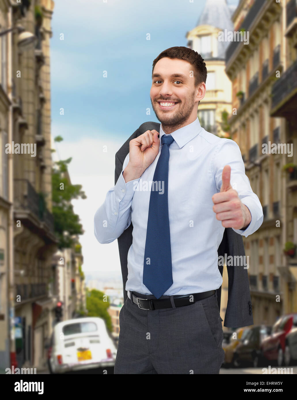 smiling young businessman showing thumbs up Stock Photo - Alamy