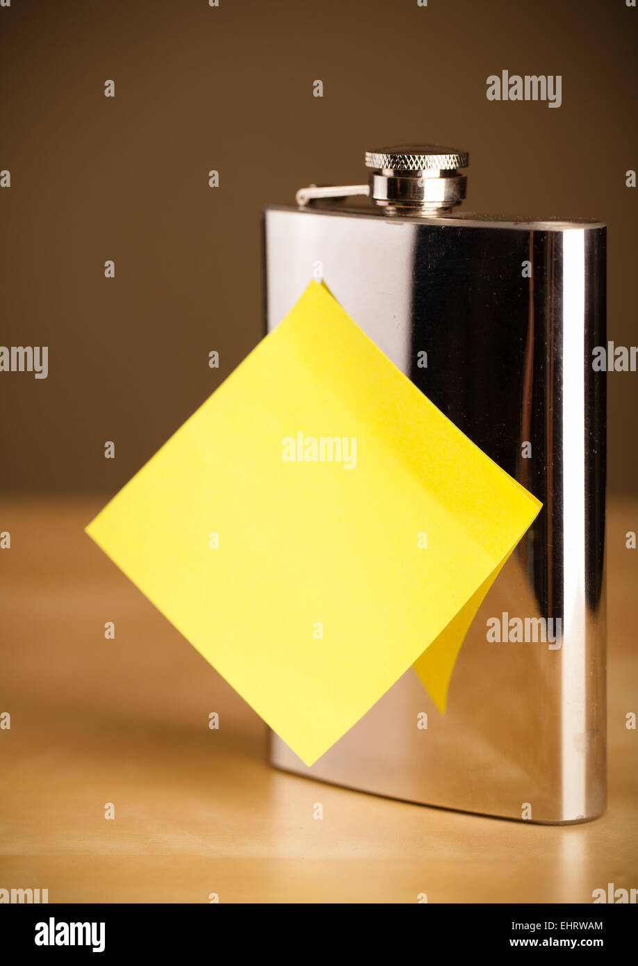 Empty post-it note sticked on hip flask Stock Photo - Alamy