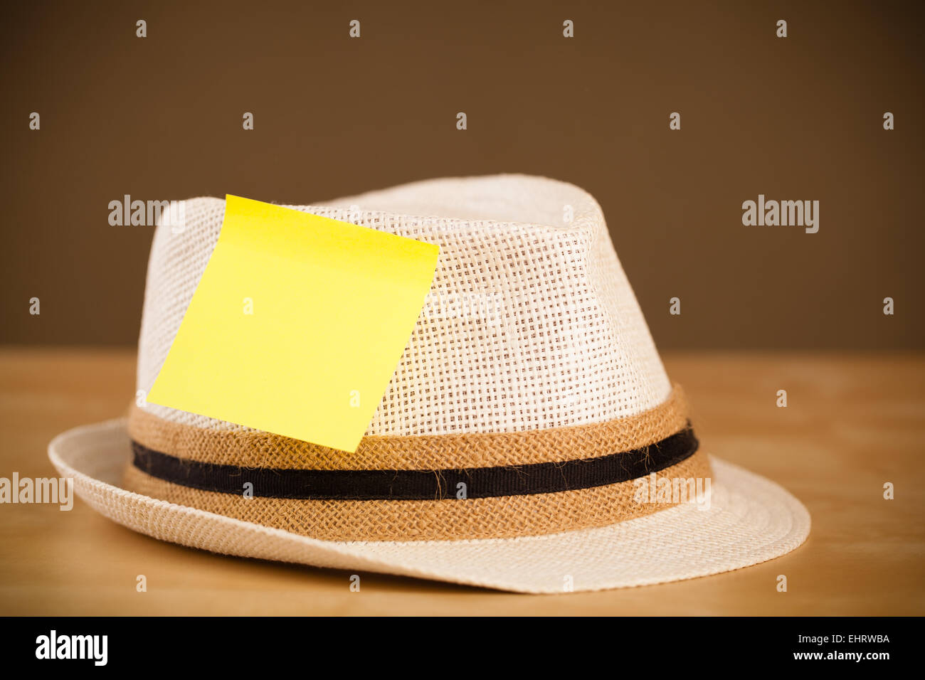 Empty post-it note sticked on hat Stock Photo - Alamy