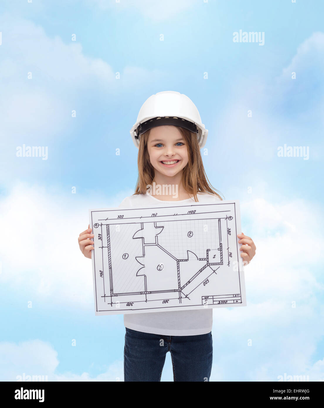 smiling little girl in helmet showing blueprint Stock Photo - Alamy