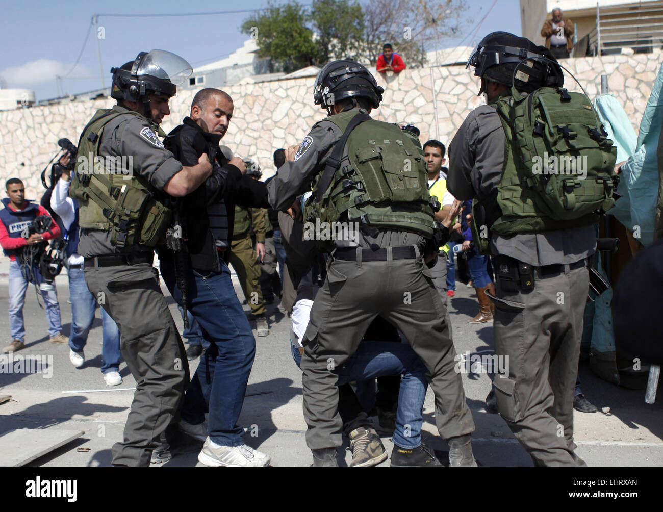 Abu Dis, West Bank, Palestinian Territory. 17th Mar, 2015. Israeli soldiers detain a Palestinian ...