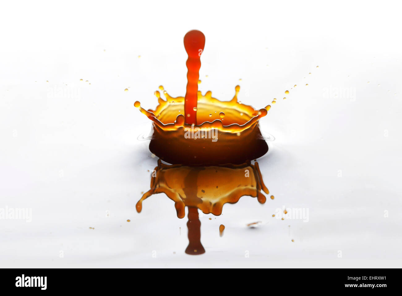 Brown liquid splash of coffee or cola isolated on white background ...