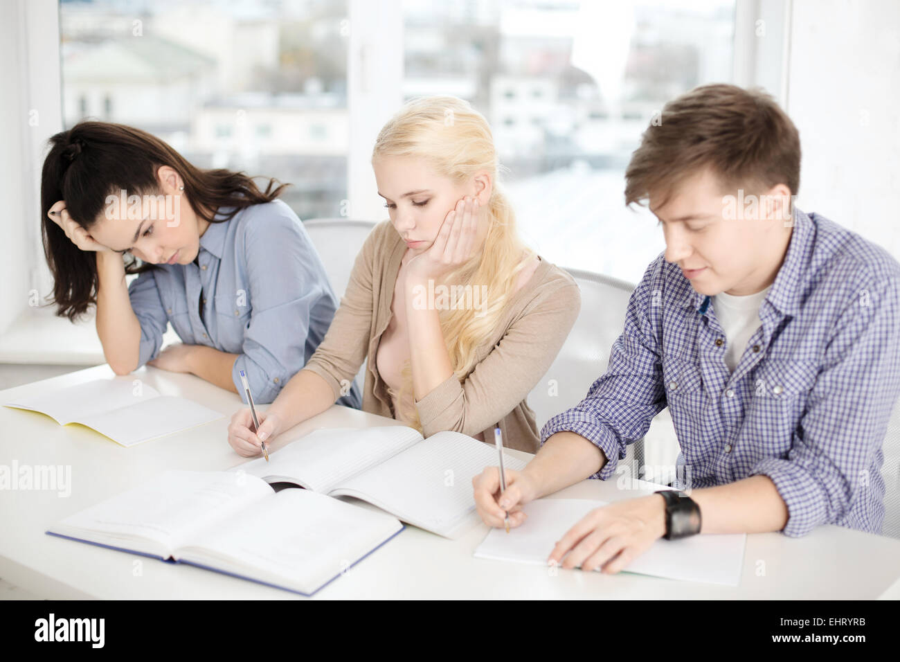 tired students with notebooks at school Stock Photo - Alamy