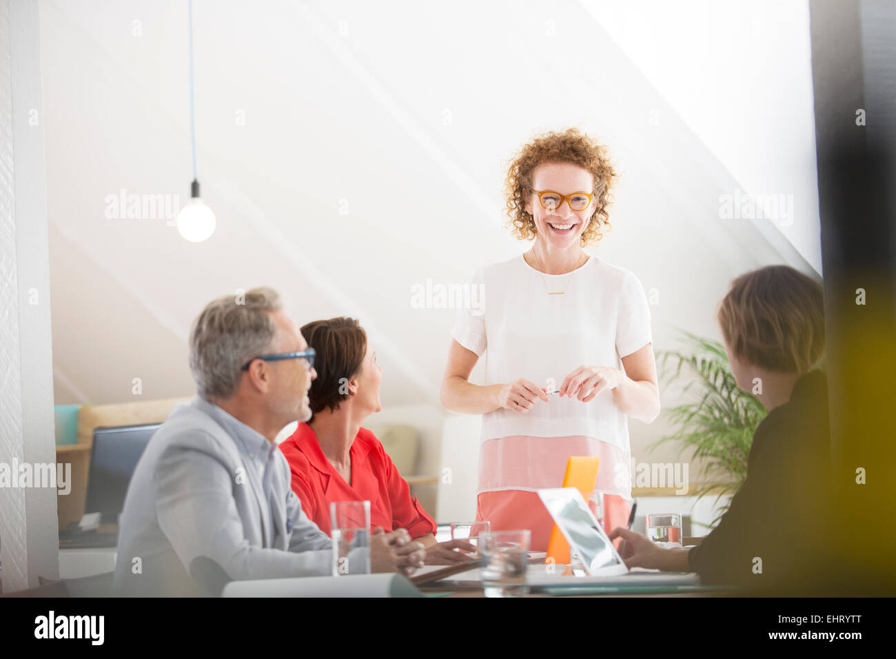 Four people at meeting in office Stock Photo - Alamy