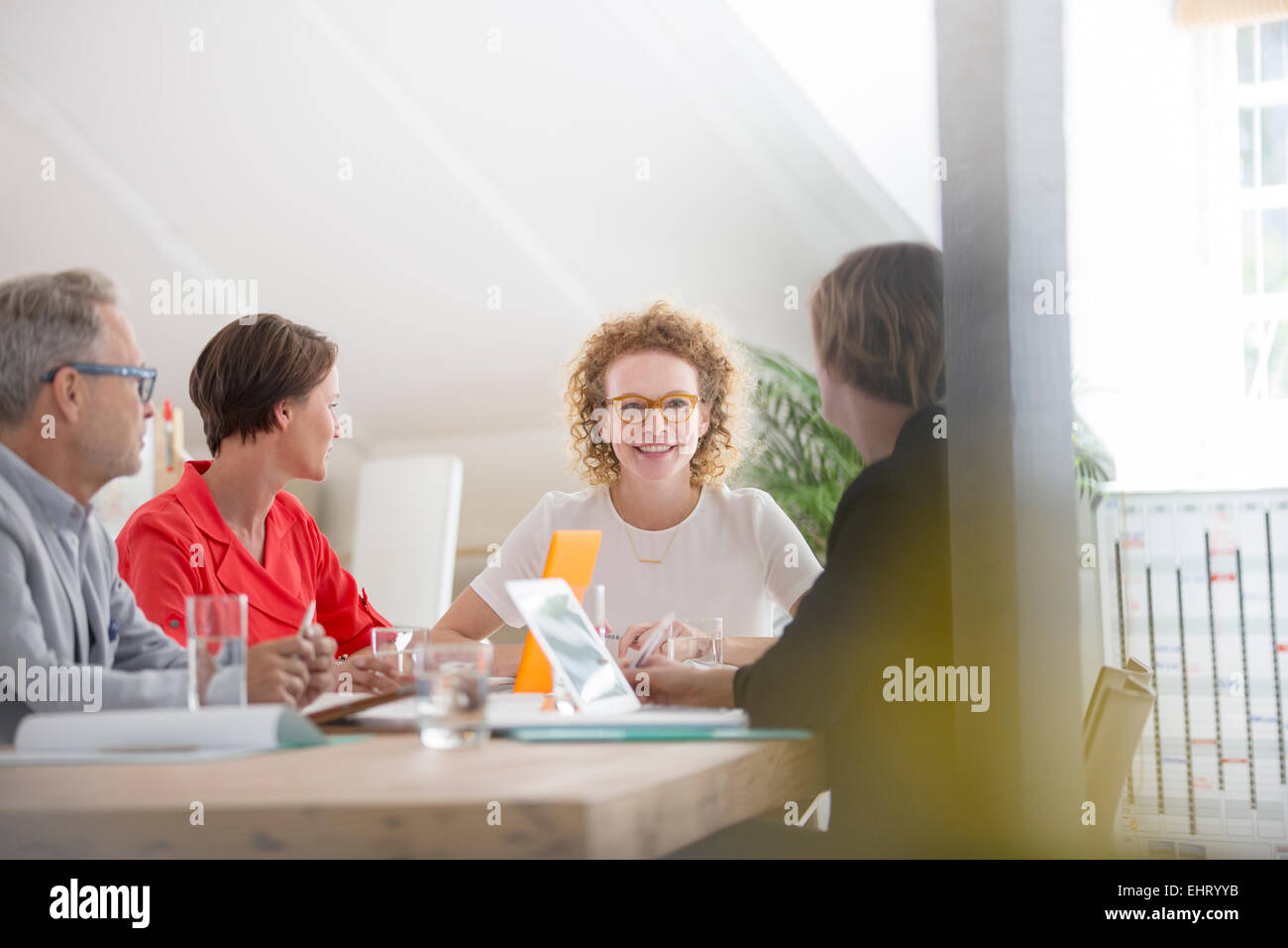 Four people at meeting in office Stock Photo - Alamy