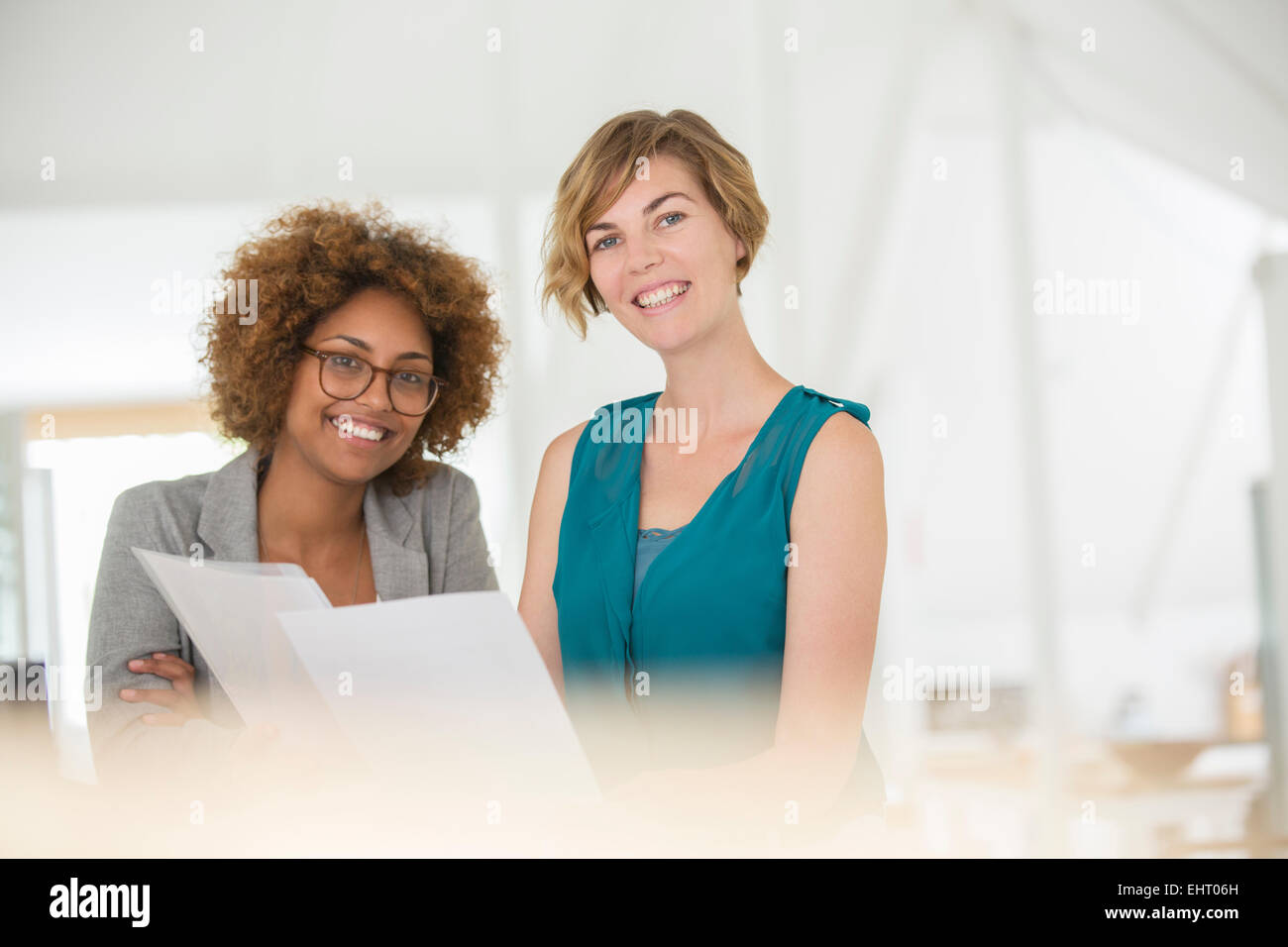 Portrait of two smiling office workers Stock Photo - Alamy