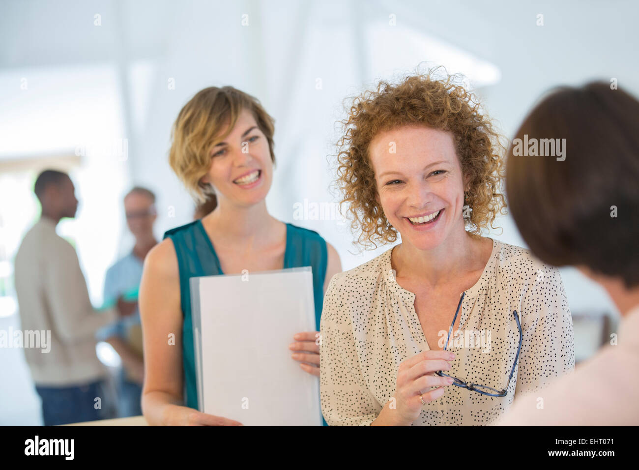 Office workers chatting and laughing during meeting Stock Photo - Alamy
