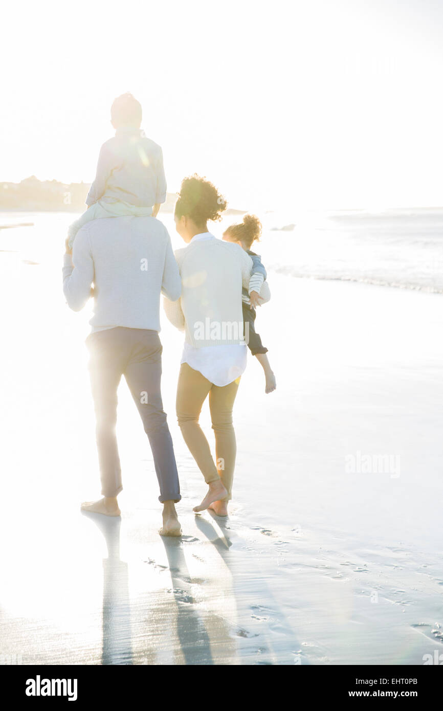 Family walking on beach in sunlight Stock Photo - Alamy