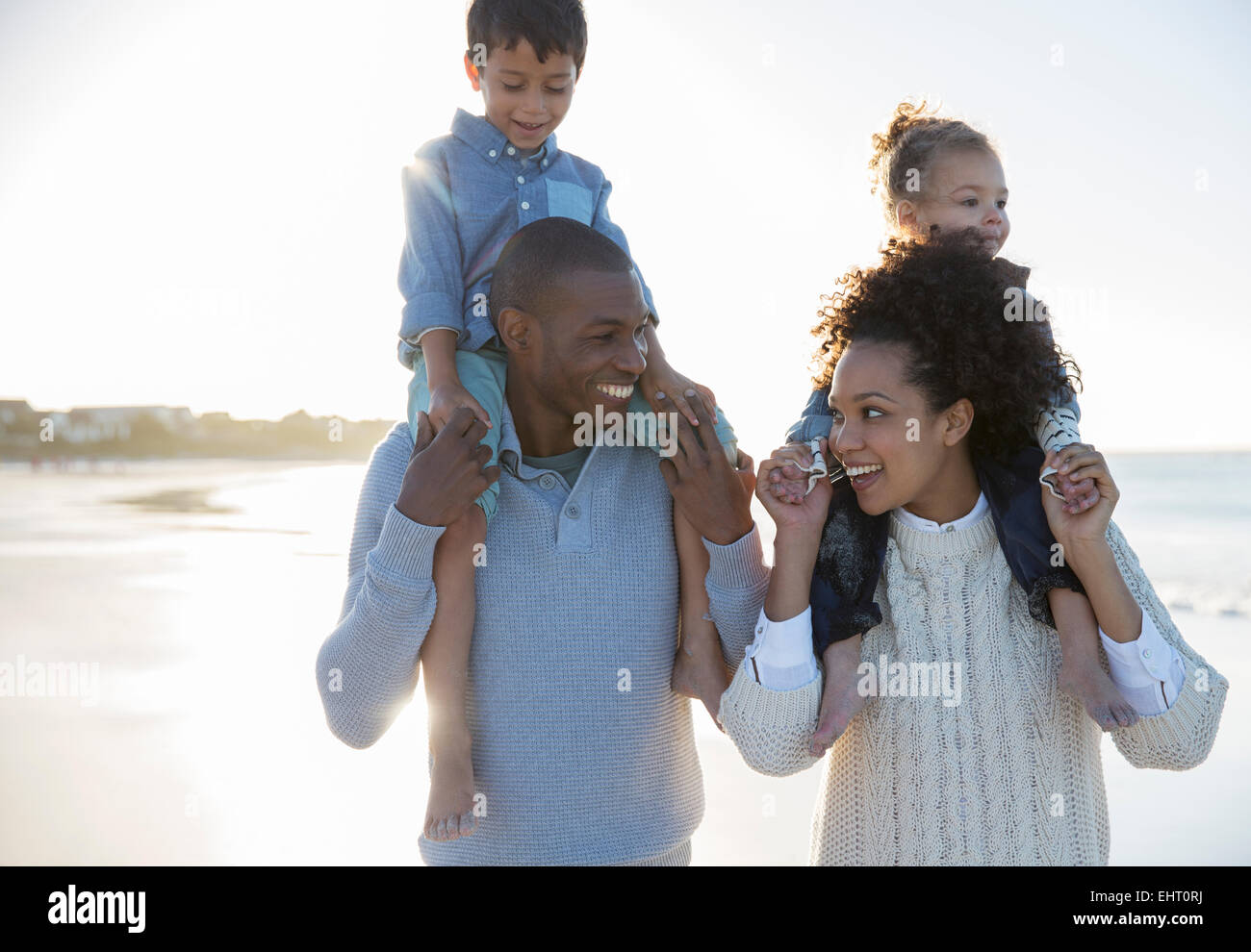 Happy family having fun on beach Stock Photo - Alamy