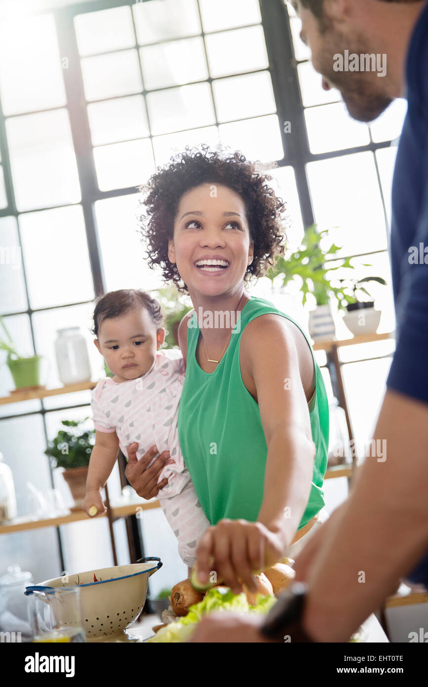 Happy family preparing meal in domestic kitchen Stock Photo - Alamy