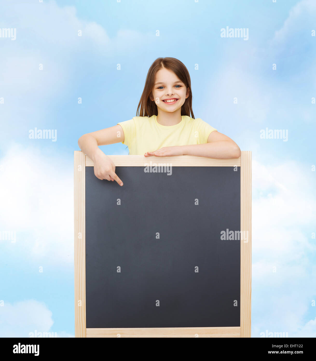 happy little girl pointing finger to blackboard Stock Photo - Alamy