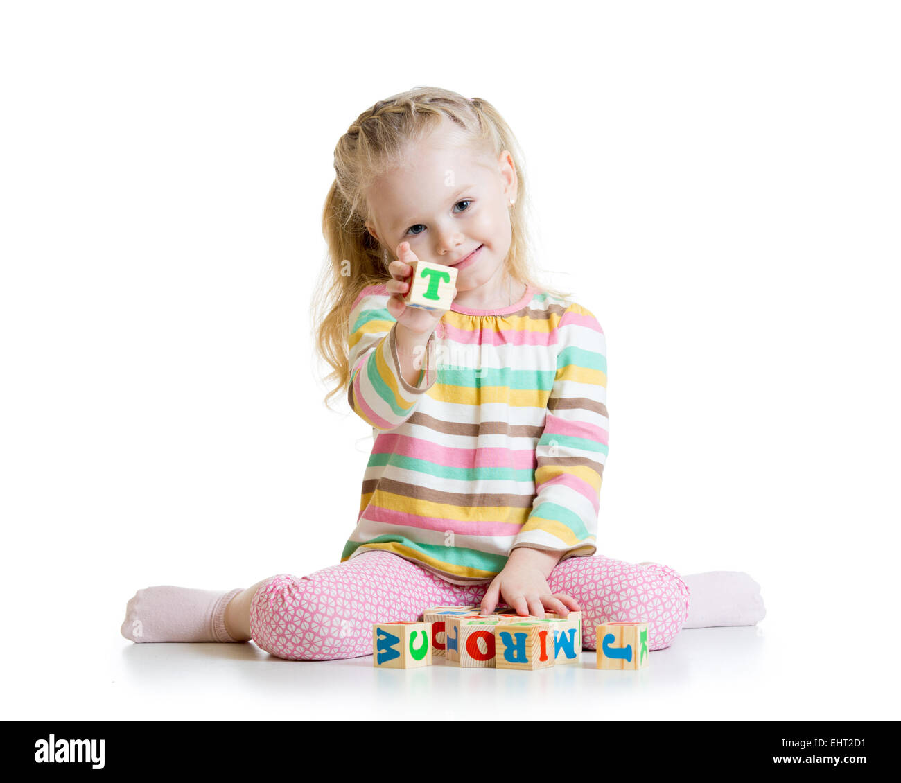 child plays with building blocks and learning of letters Stock Photo ...