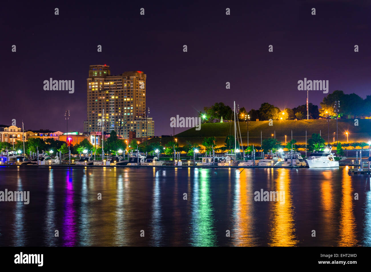 A marina and Federal Hill at night at the Inner Harbor in Baltimore ...