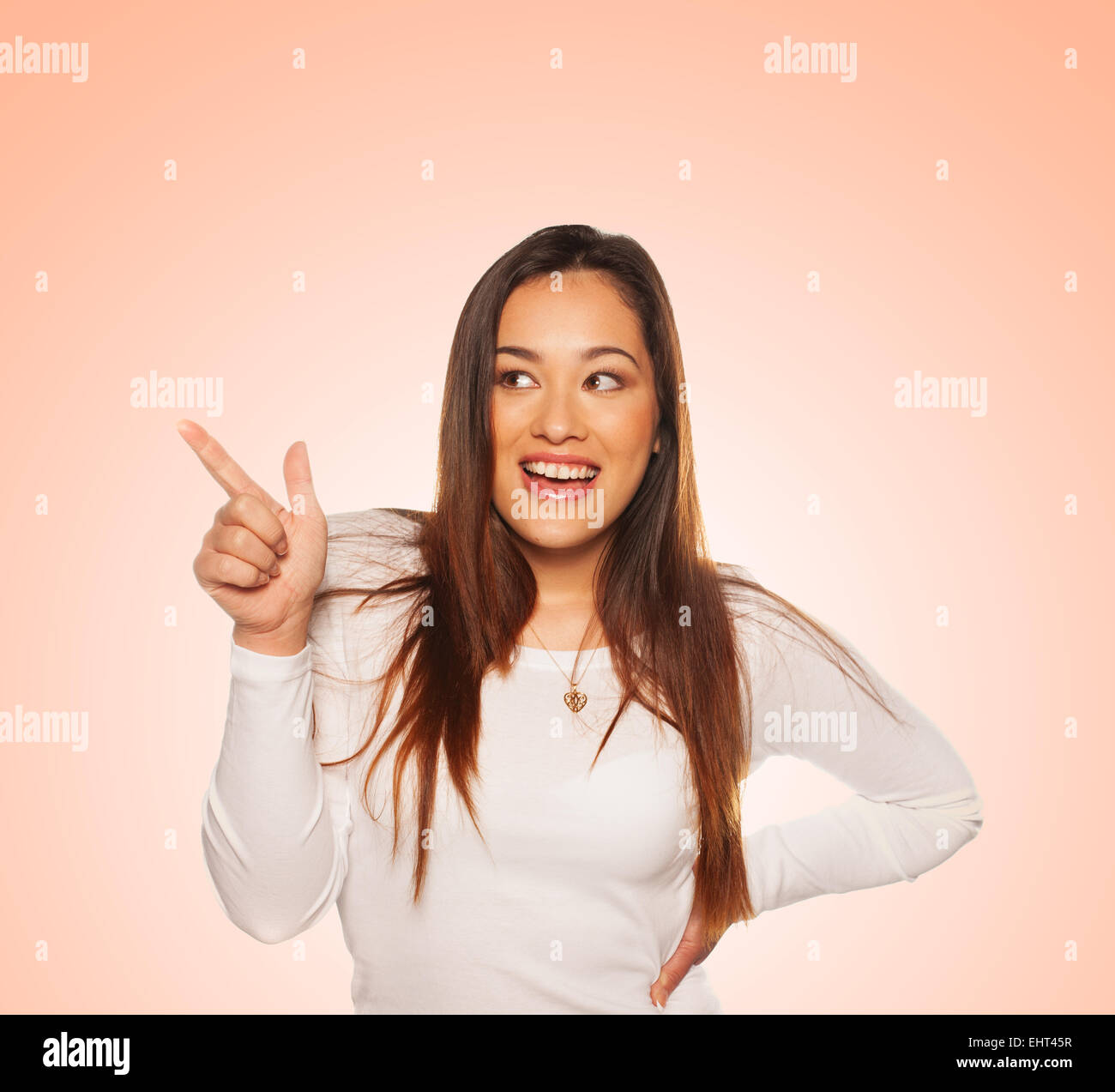 Pretty and happy young woman pointing Stock Photo - Alamy