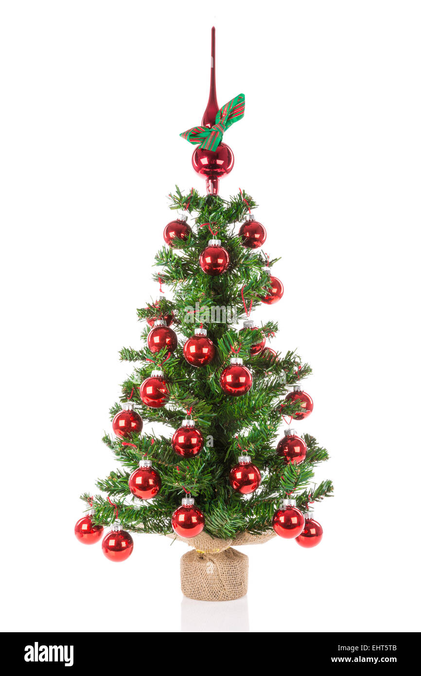 Decorated Christmas tree with red peak balls over a white background ...