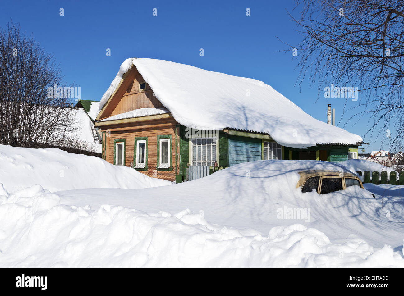 Wooden house and a car in snow drifts Stock Photo - Alamy