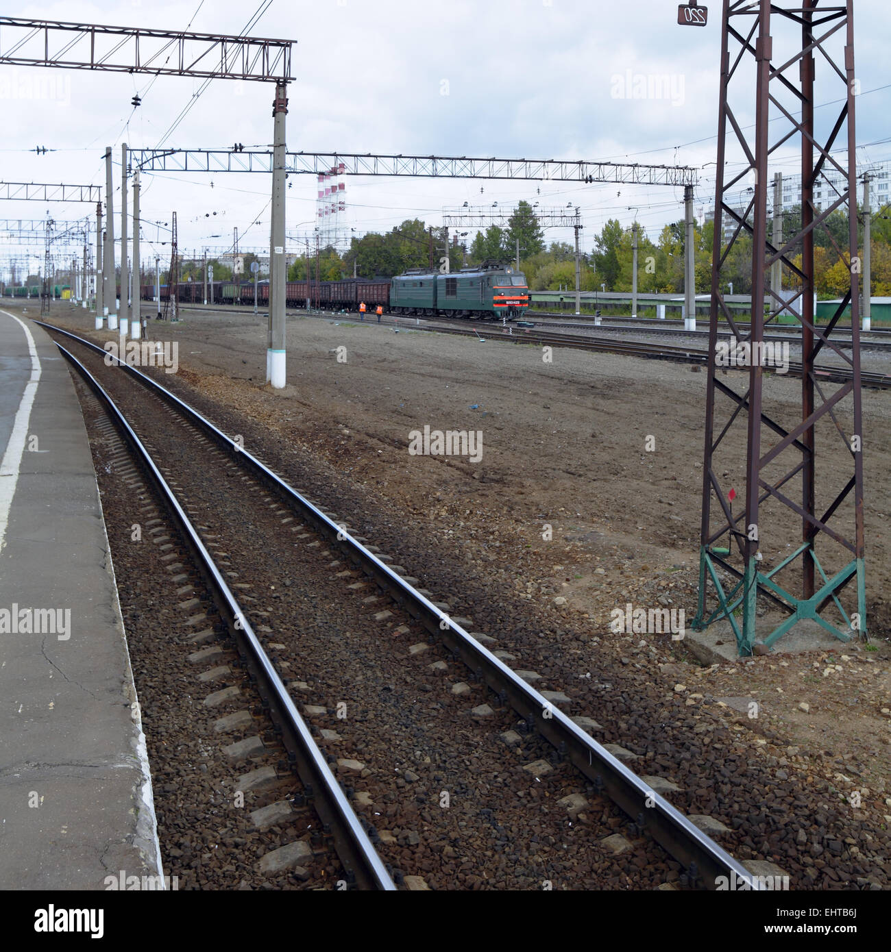 Cargo train on a railway station Stock Photo - Alamy