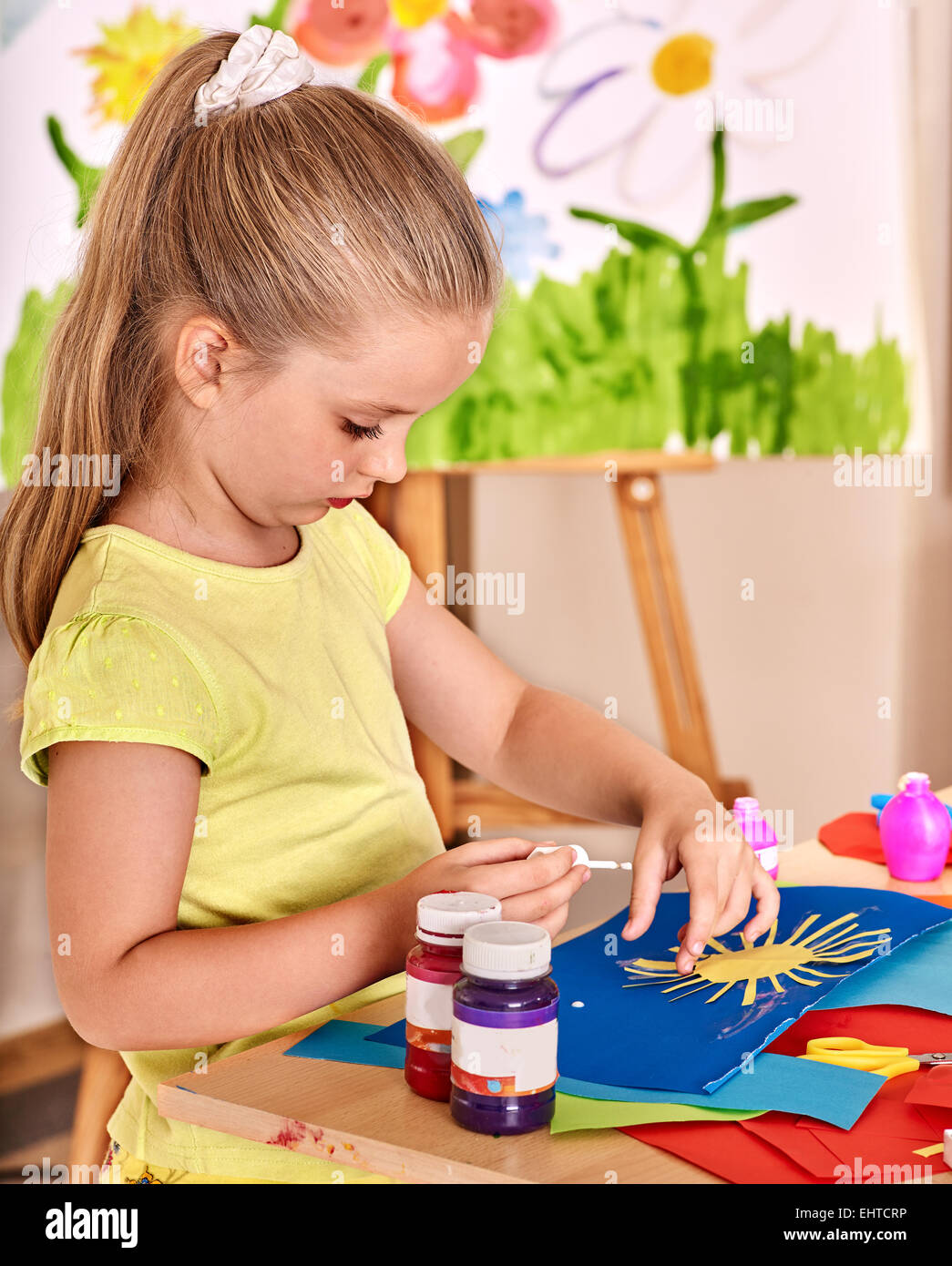 Child girl glue in preschool Stock Photo - Alamy
