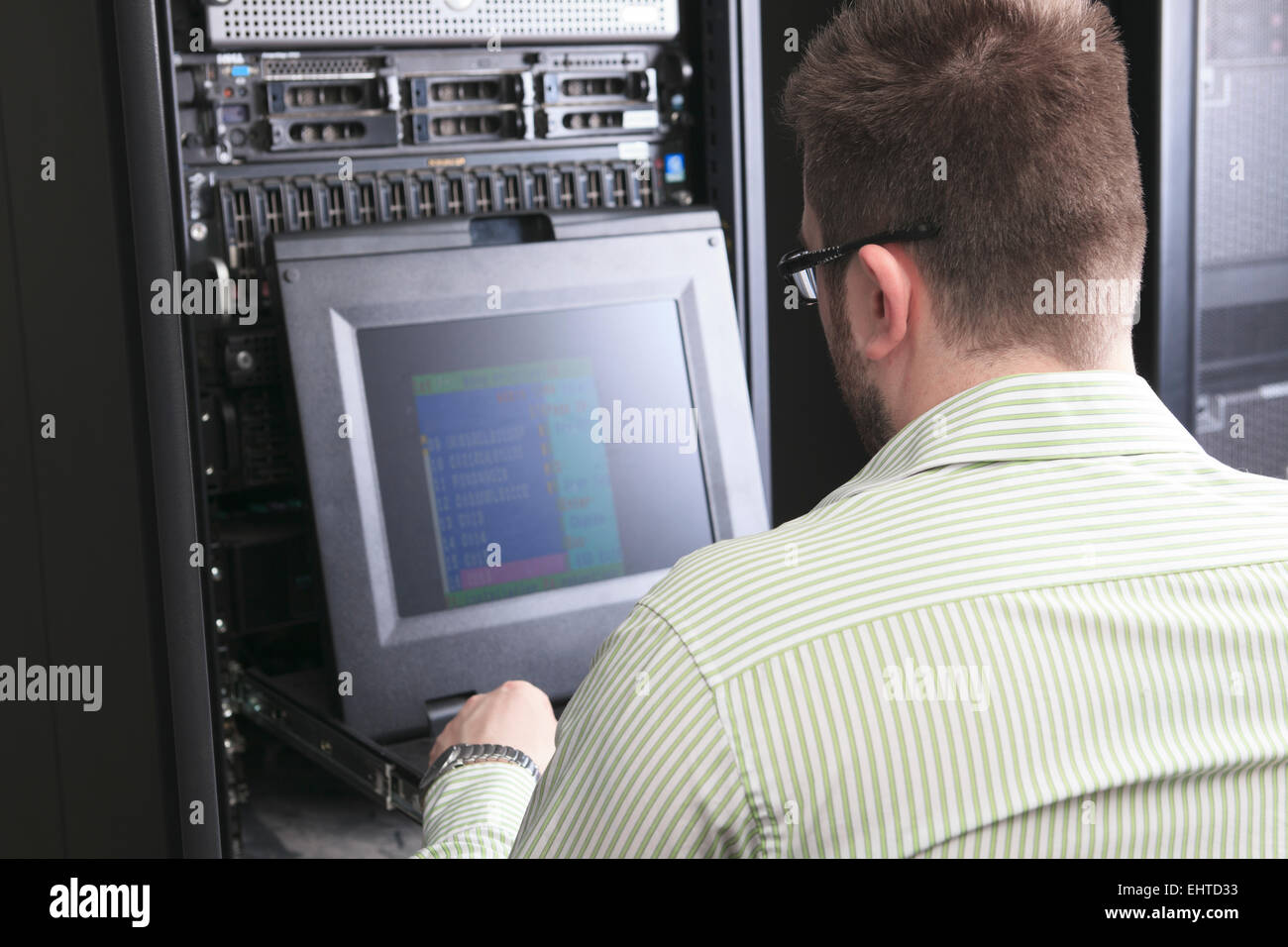 Network engineer working in server room Stock Photo - Alamy
