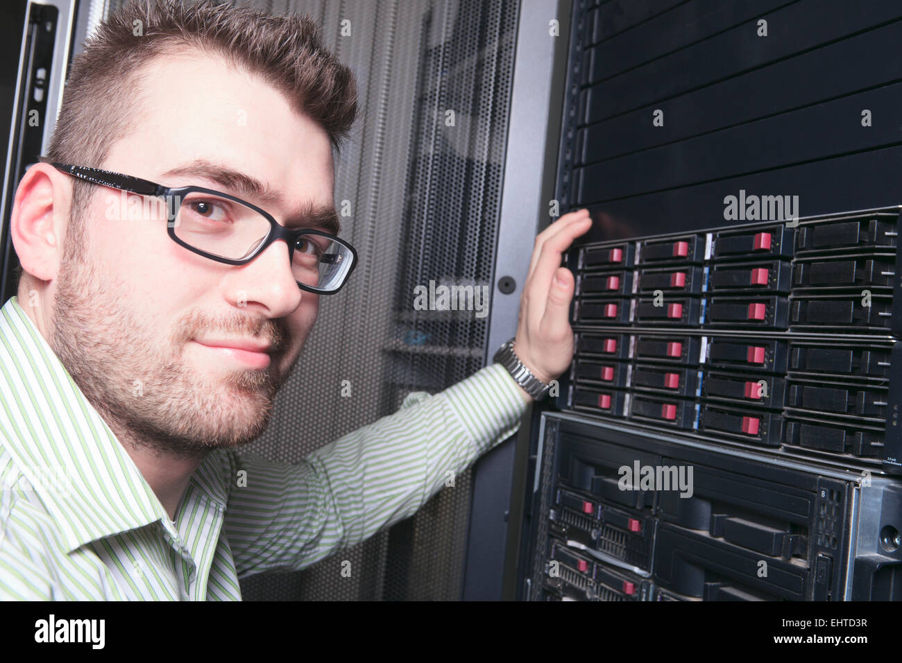 Network engineer working in server room Stock Photo - Alamy