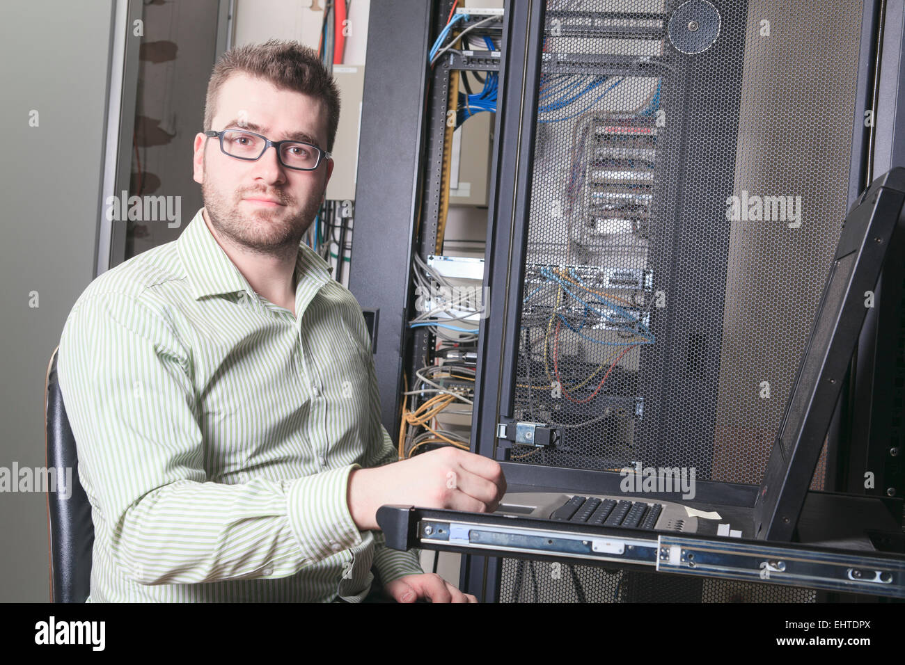 Network engineer working in server room Stock Photo - Alamy