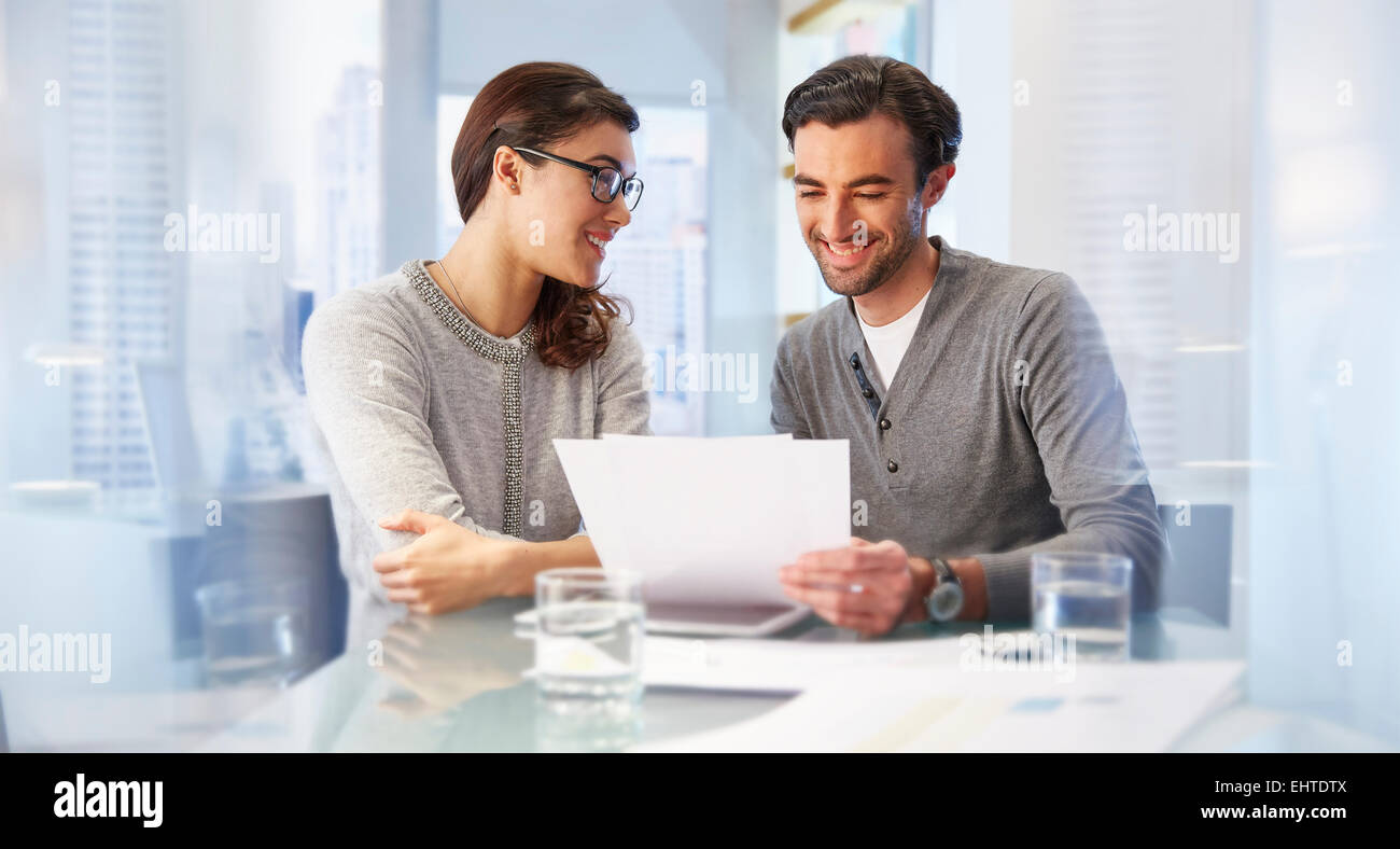 Man and woman working together in office Stock Photo - Alamy