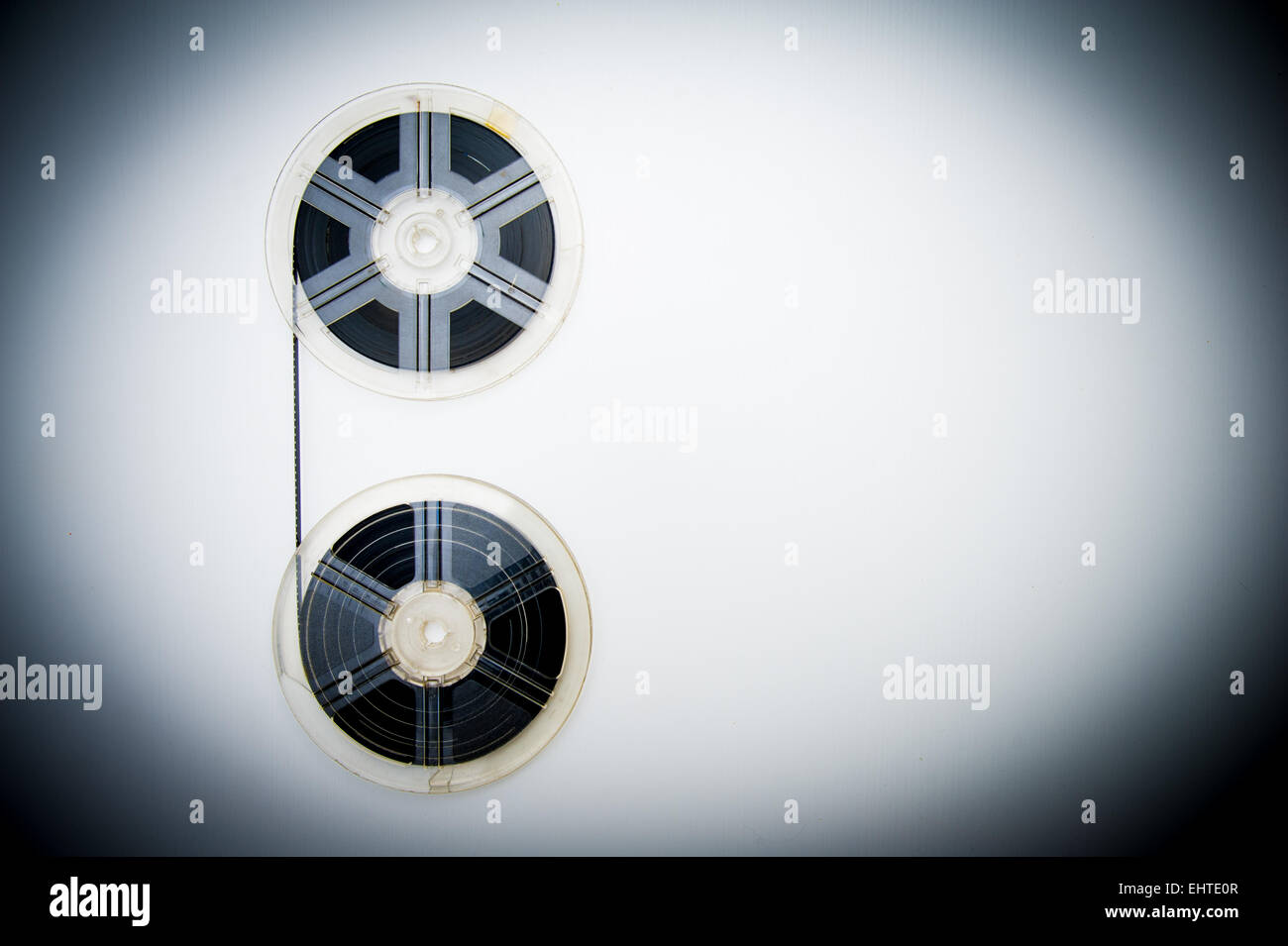 Two vintage 8mm reels vertically connected with film vintage color ...