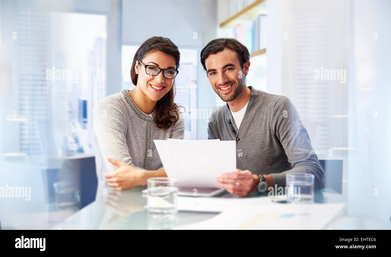 Portrait of man and woman working together in office Stock Photo - Alamy
