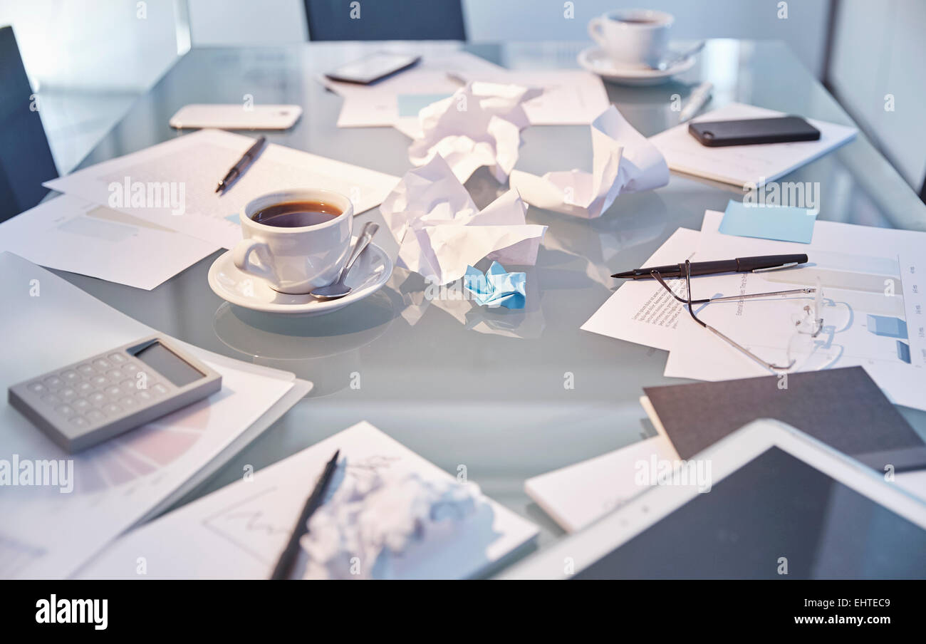 Messy table in conference room of modern office Stock Photo - Alamy
