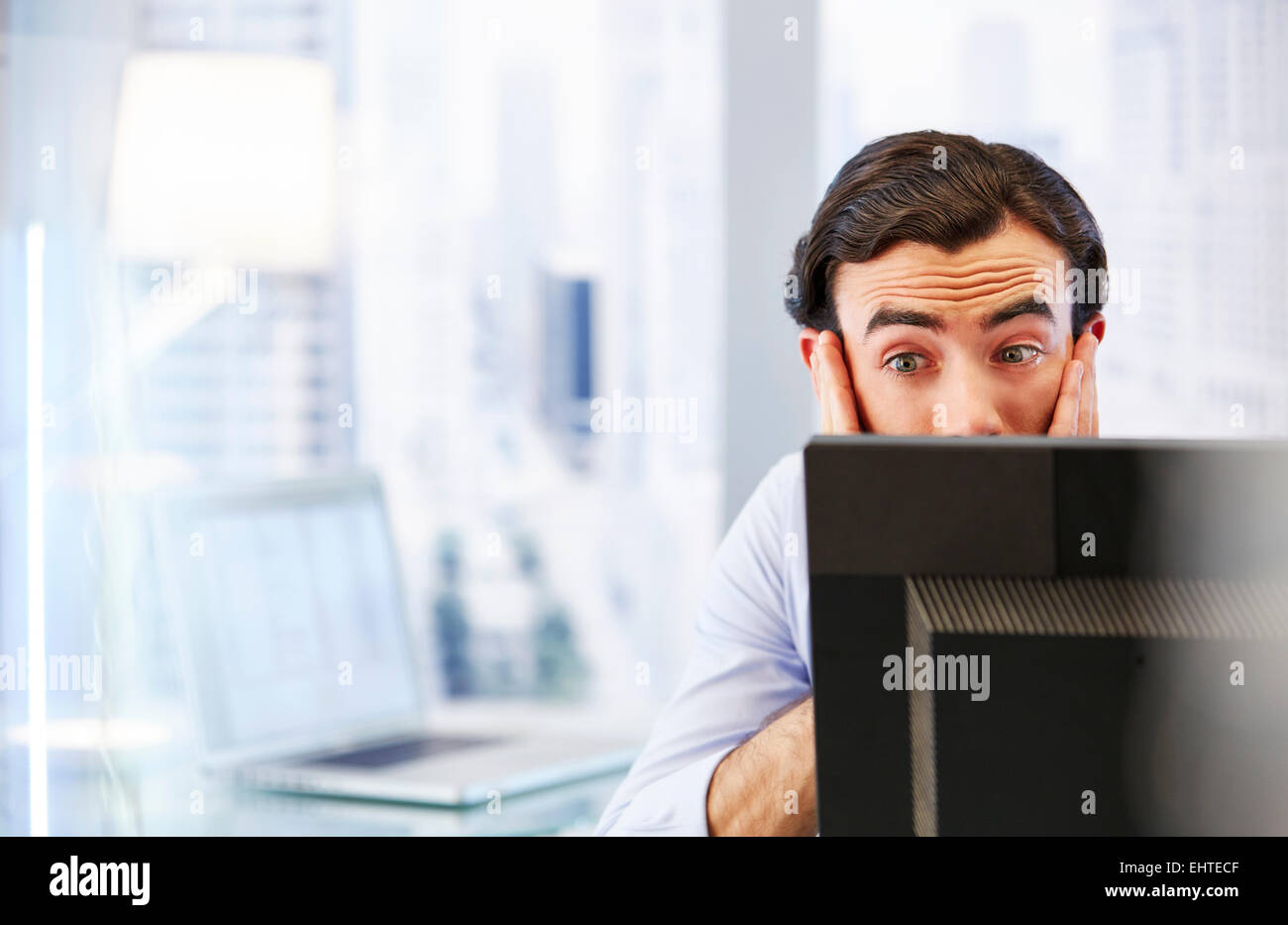 Man using computer in office,stressed and worried Stock Photo - Alamy