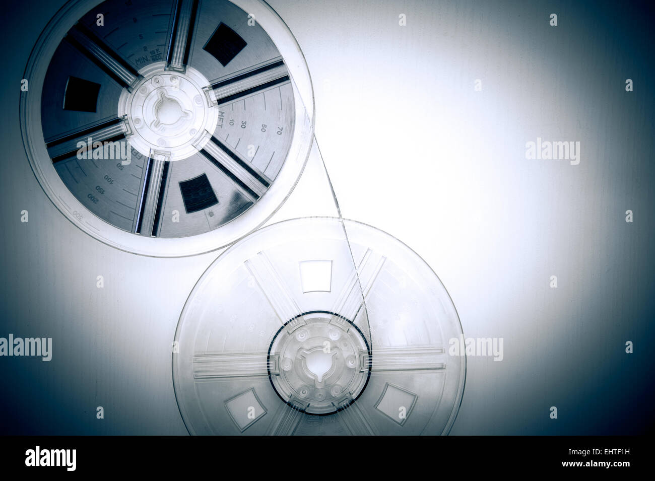 Two transparent 8mm movie reels connected with film in vintage color ...