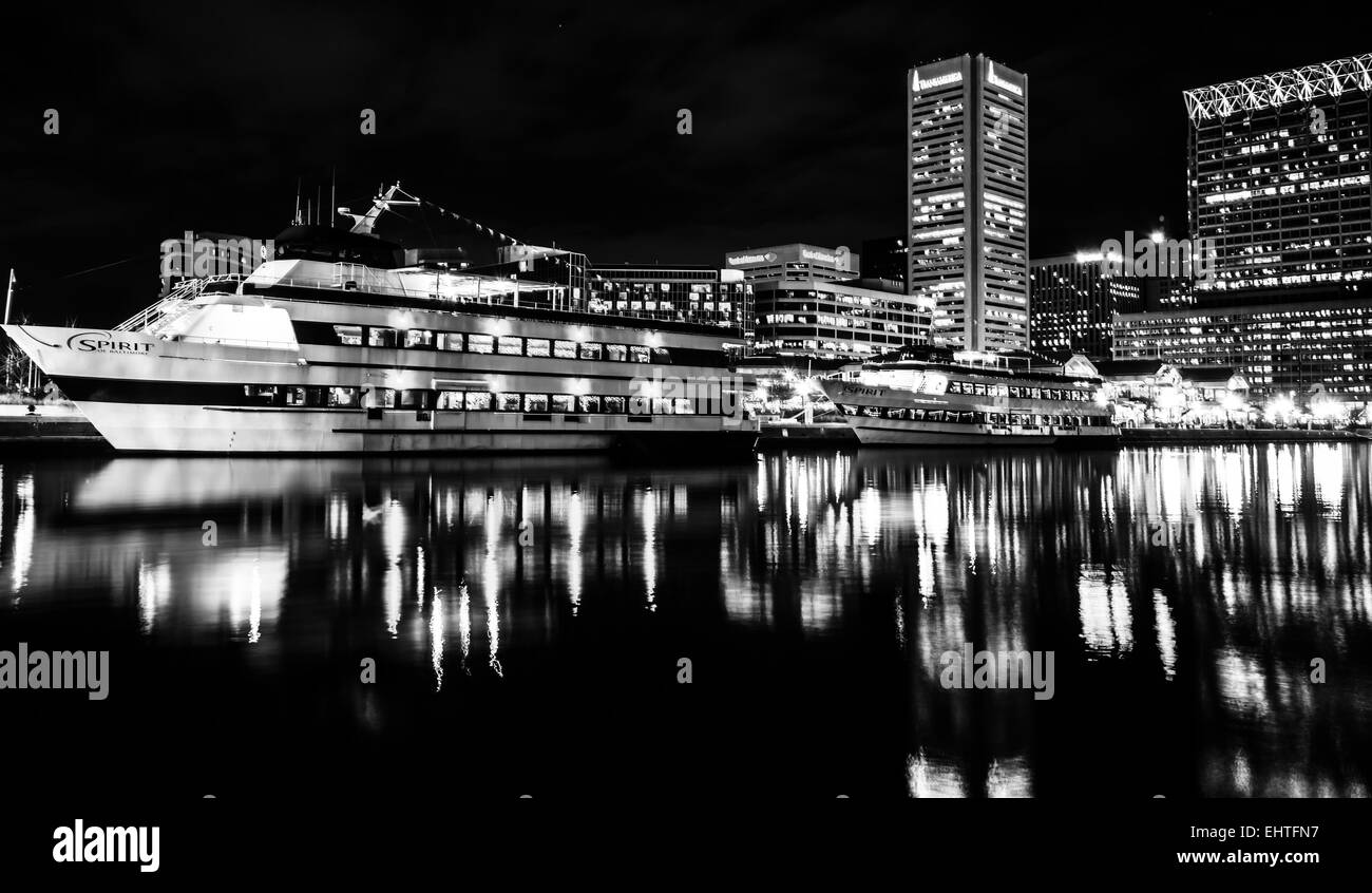 Buildings and boats reflecting in the Inner Harbor at night, Baltimore ...