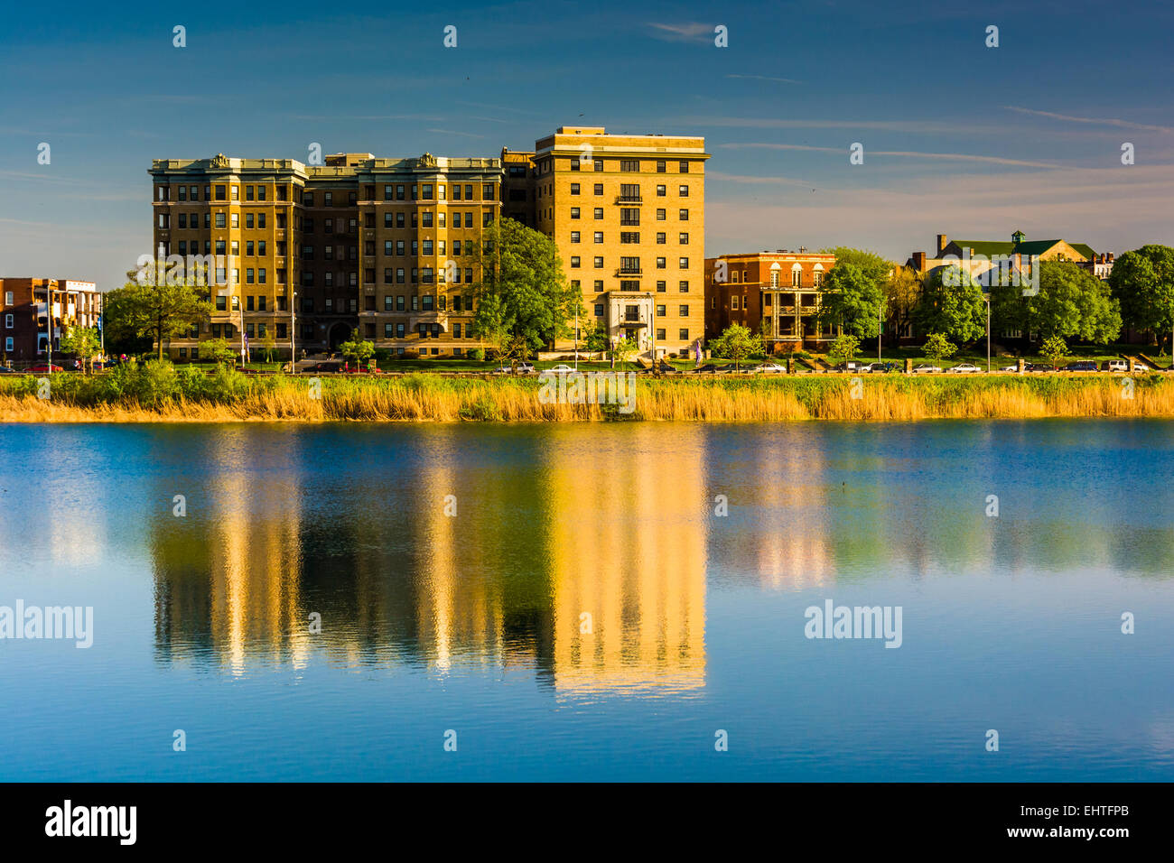 Buildings reflecting in Druid Lake, at Druid Hill Park in Baltimore ...