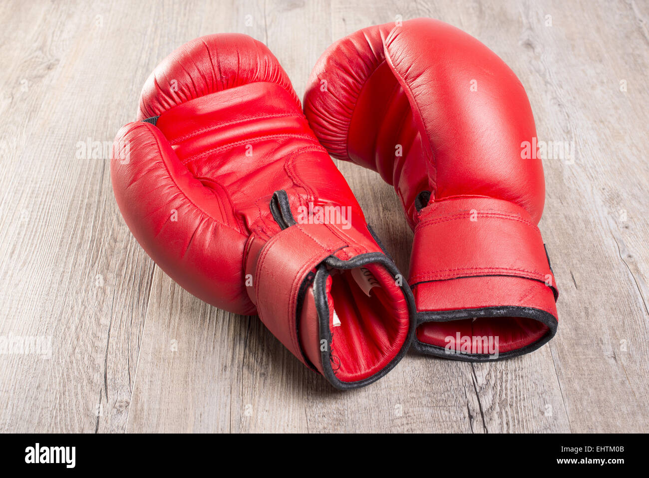 two boxing gloves on the wooden table Stock Photo - Alamy