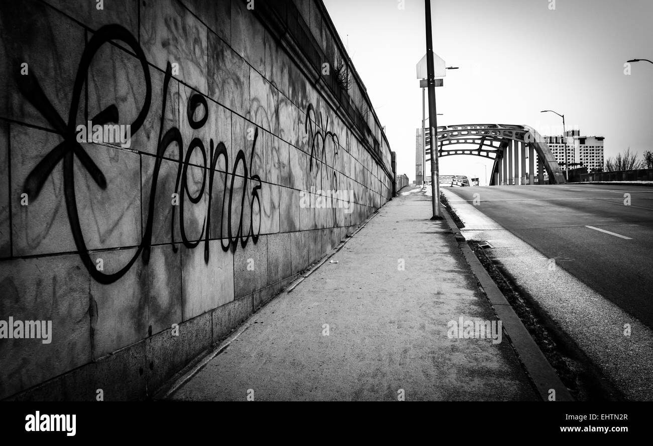 Graffiti on a wall and the Howard Street Bridge, in Baltimore, Maryland ...
