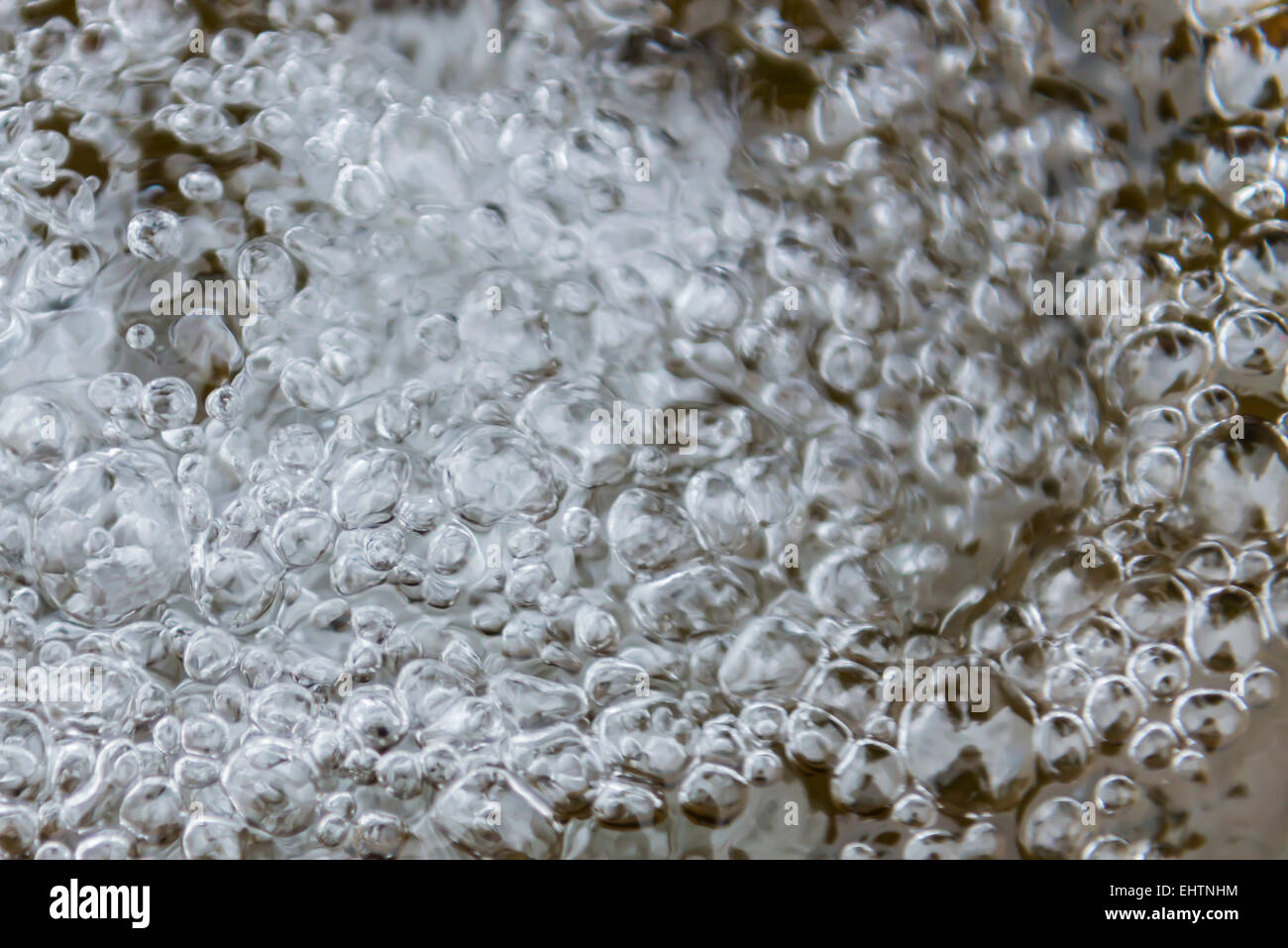 Streaming water with bubbles Stock Photo - Alamy