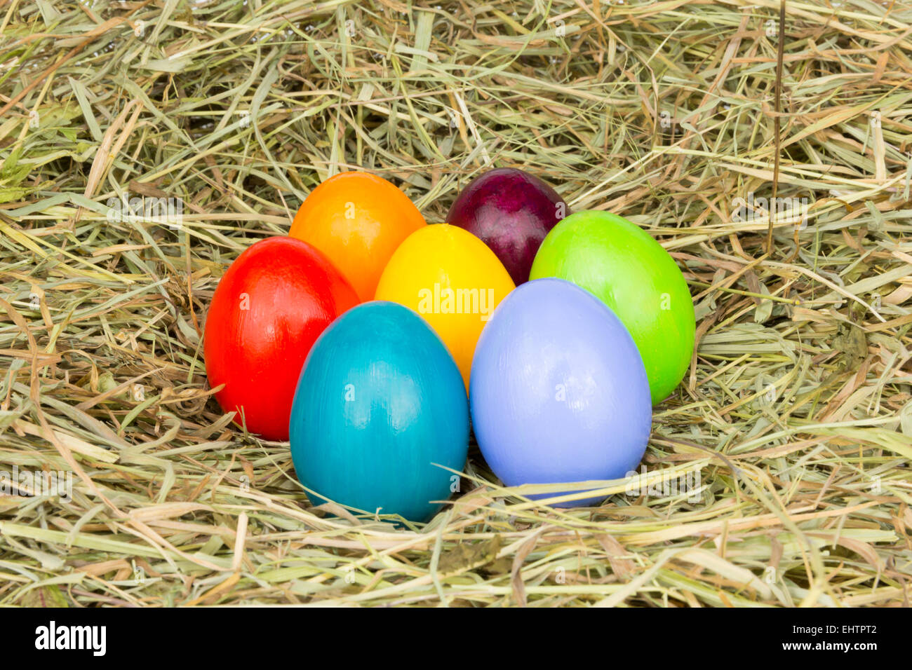 coloured easter eggs in hay and straw 13 Stock Photo - Alamy