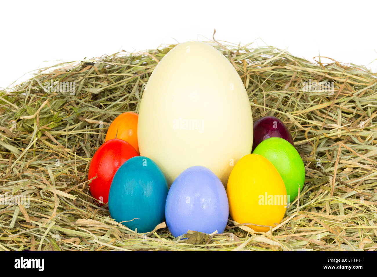 coloured easter eggs in hay and straw 7 Stock Photo - Alamy