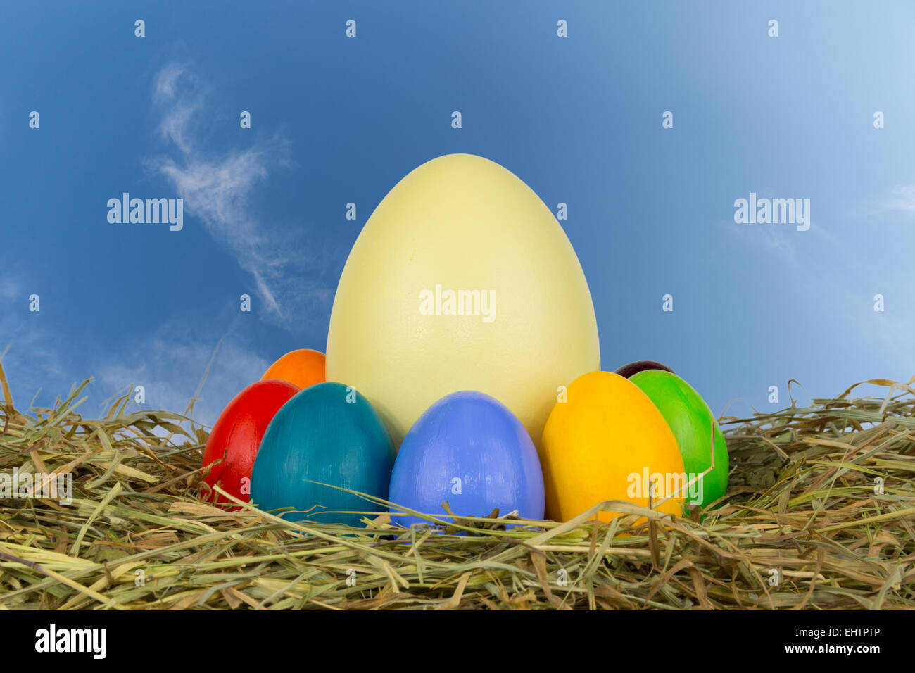 coloured easter eggs in hay and straw 2 Stock Photo - Alamy
