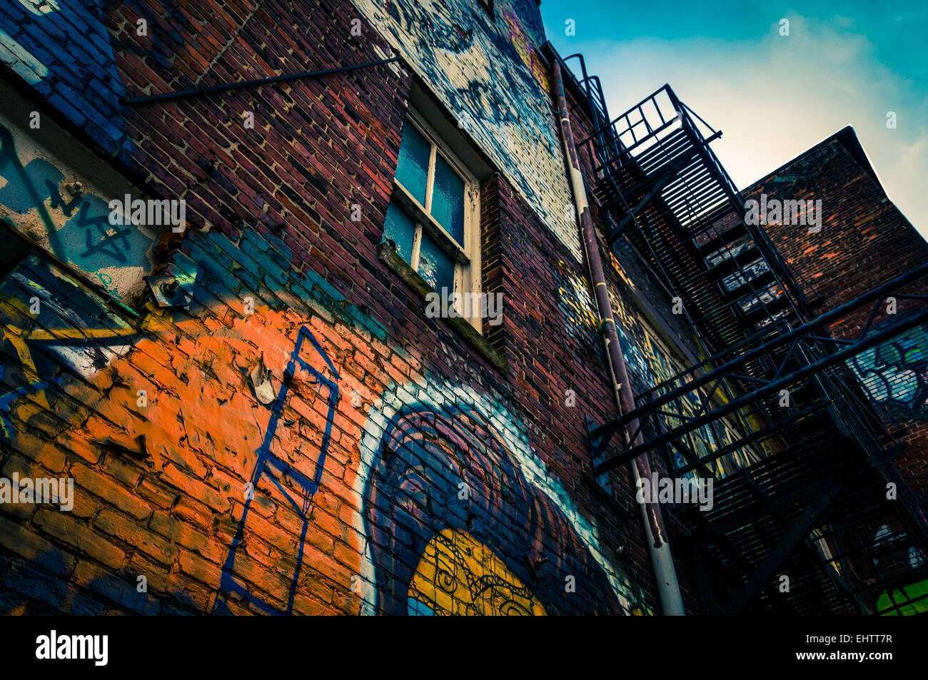 Looking up at graffiti and old staircases in Graffiti Alley, Baltimore ...
