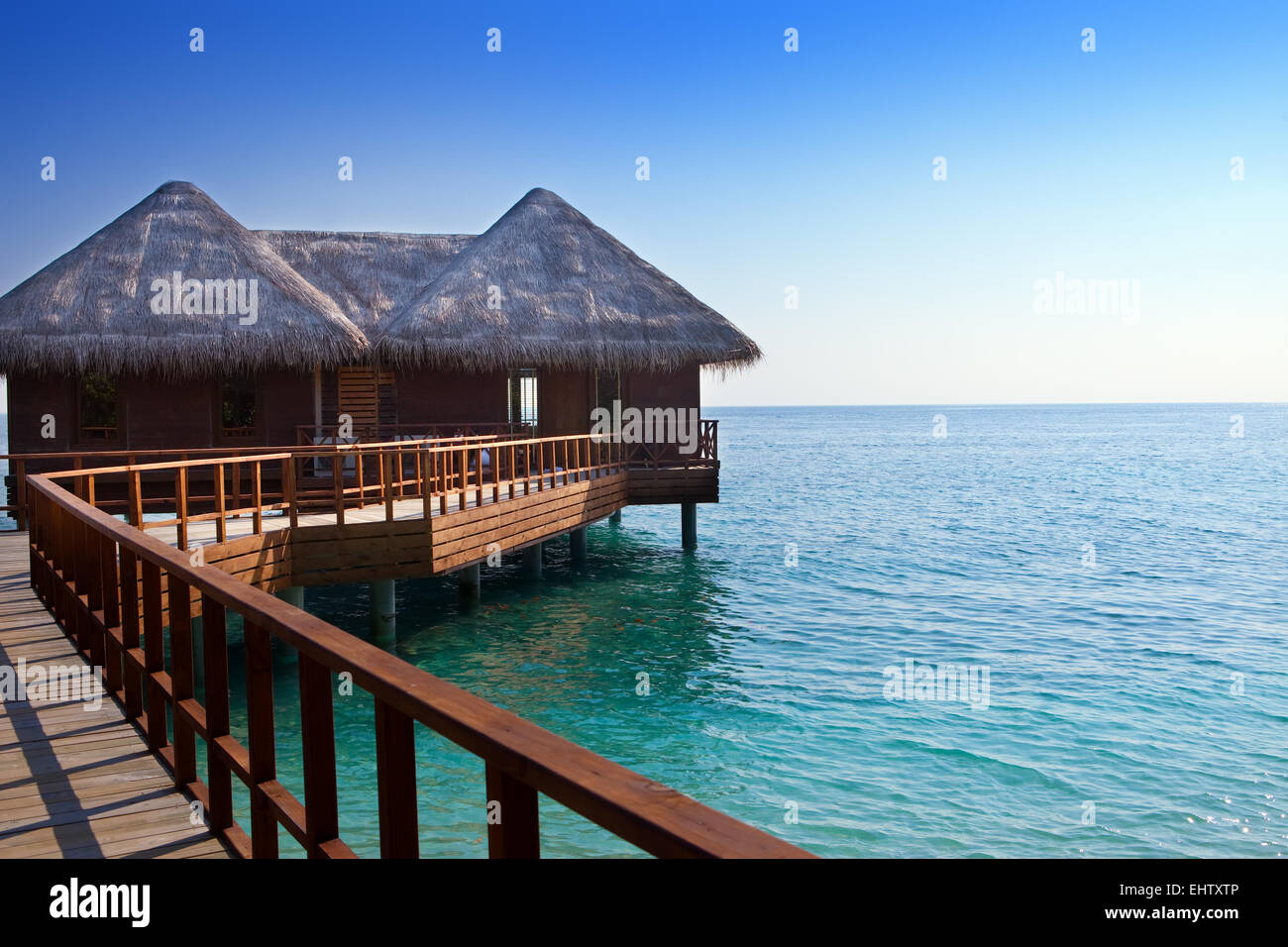 Island in ocean, overwater villas Stock Photo - Alamy