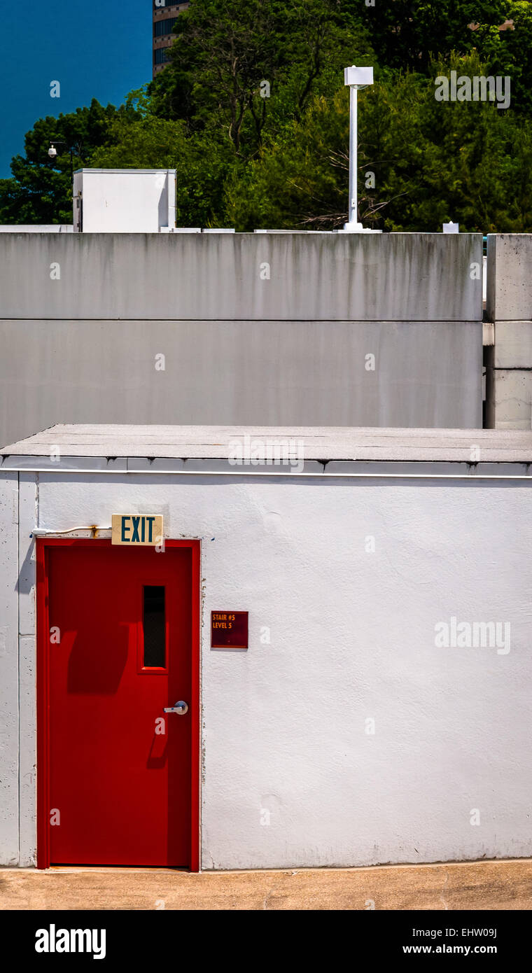 Red door and exit sign on small building in Towson, Maryland Stock ...