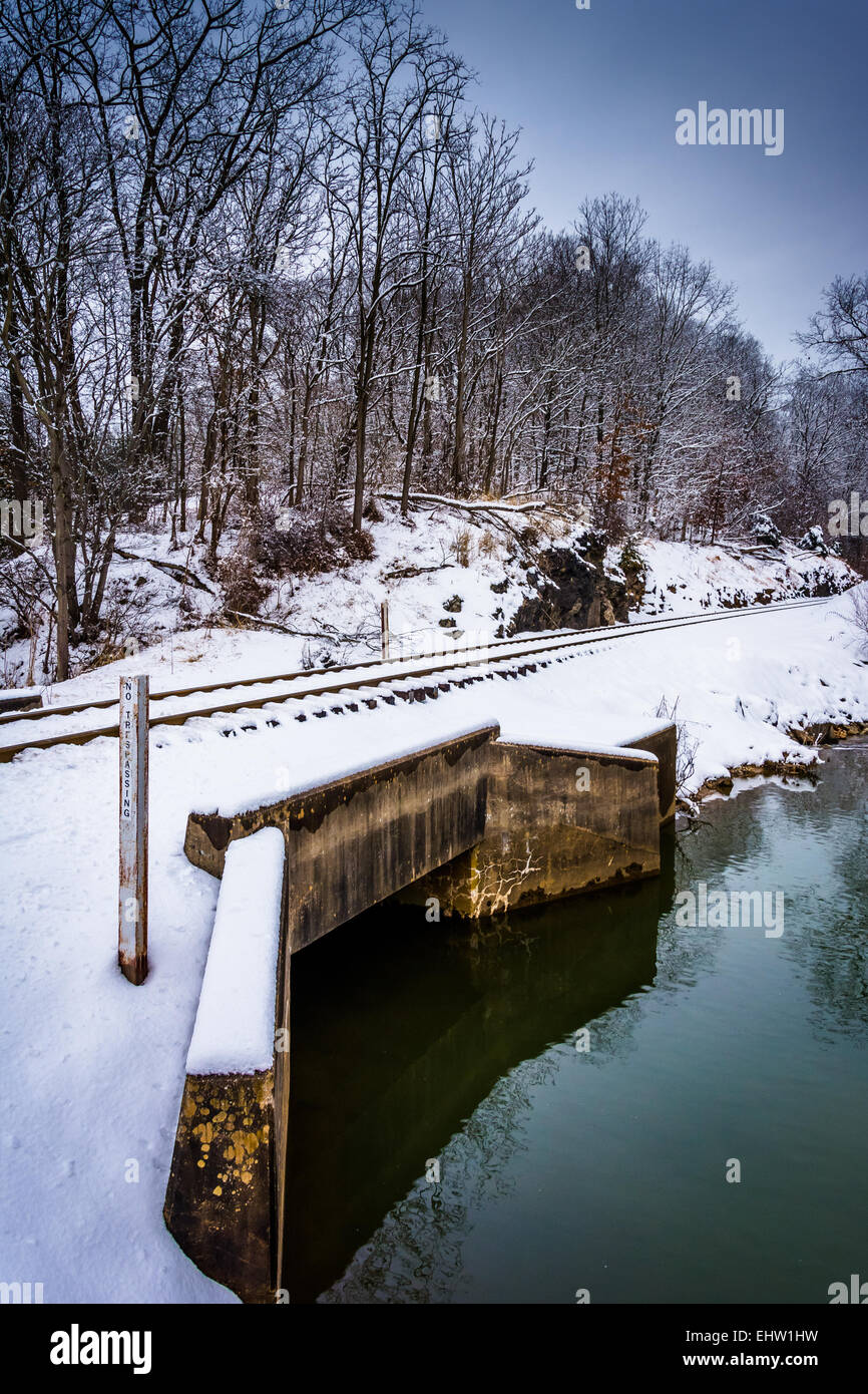 Snow covered railroad bridge over a creek in rural Carroll County ...