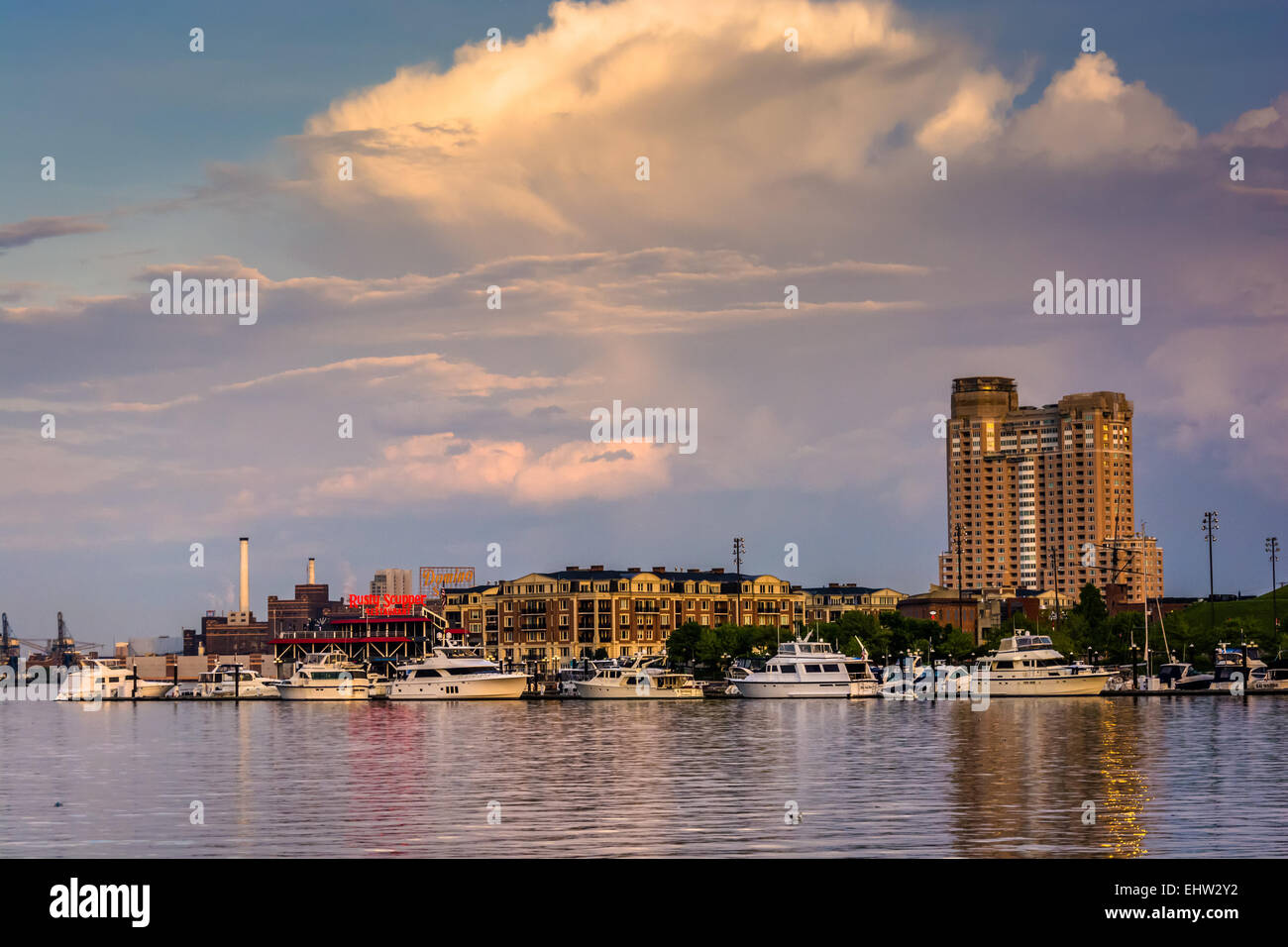 Sunset clouds over a marina and buildings in the Inner Harbor ...